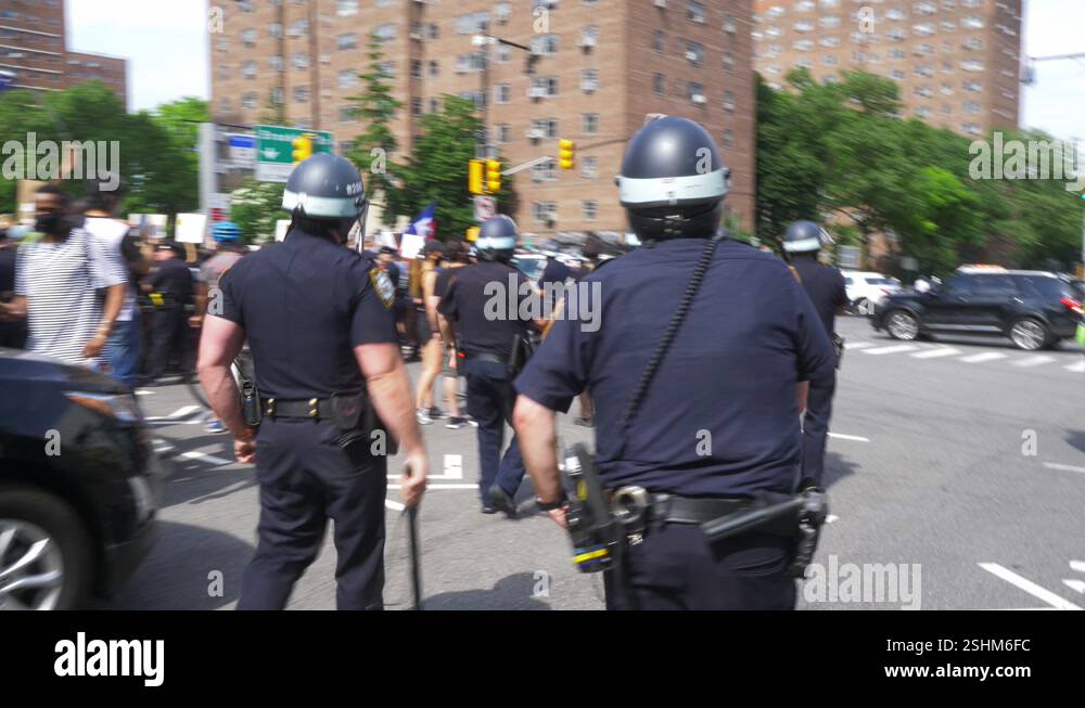 New York Police Officers in Riot Gear with Batons walking into Crowd of ...