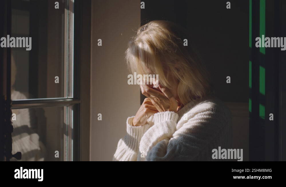 Sick mature woman cough standing near window. Realtime Stock Video ...