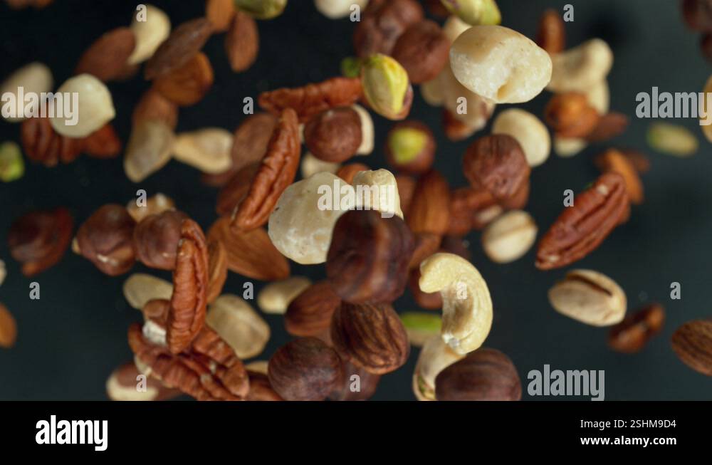 Super slow motion of rotating mix nuts up to the air Stock Video ...