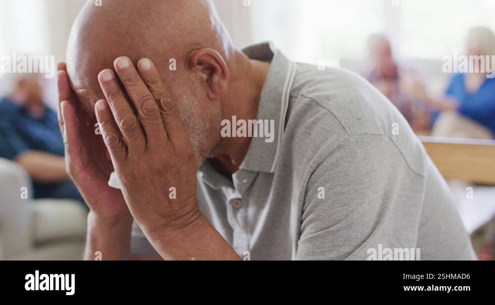 Sad senior biracial man crying at support group meeting of diverse ...