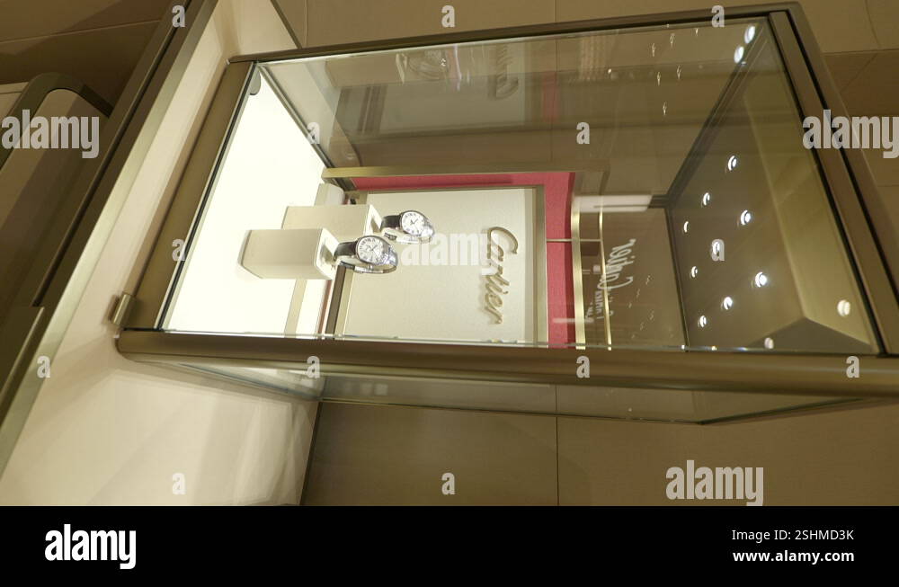 Close up of Cartier watches on display in luxury watch store. Vertical ...