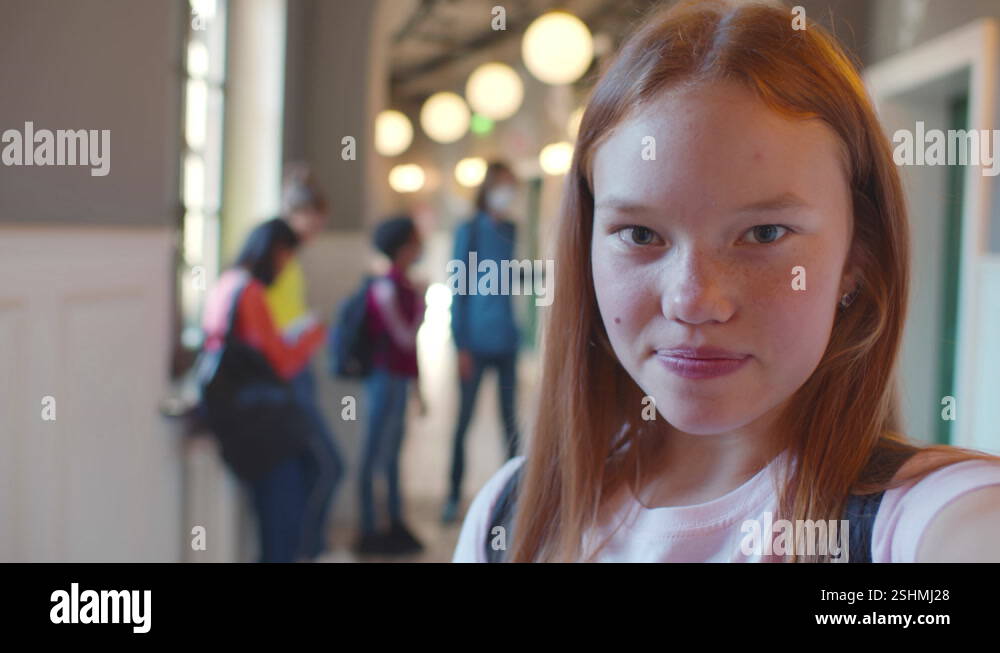 Happy teen girl vlogger holding smartphone talking to camera shooting ...