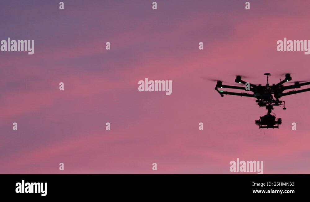 DJI S900 Mega drone flying with pink sunset in background Stock Video ...