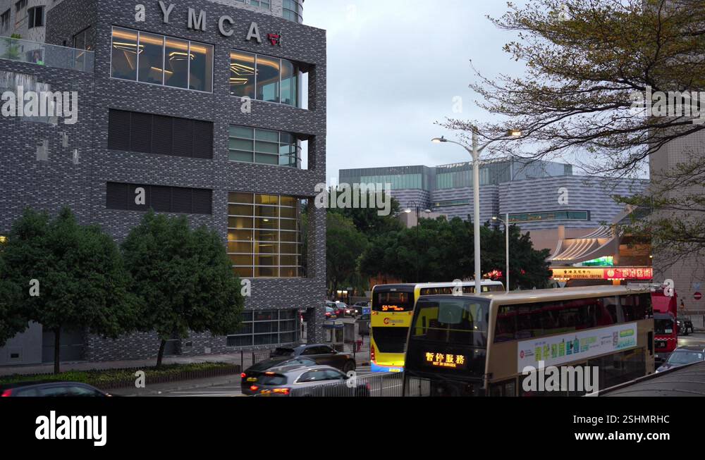 Tilt down from sign on YMCA building to street traffic in Hong Kong ...