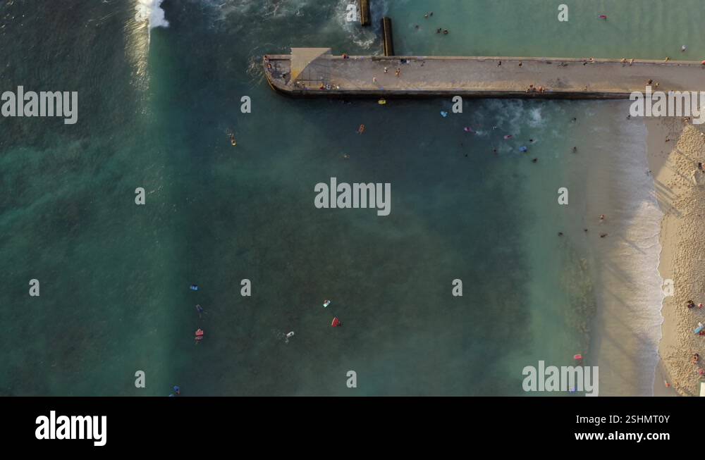 Waikiki walls beach waves roll by crashing on swimmers and beachgoers ...