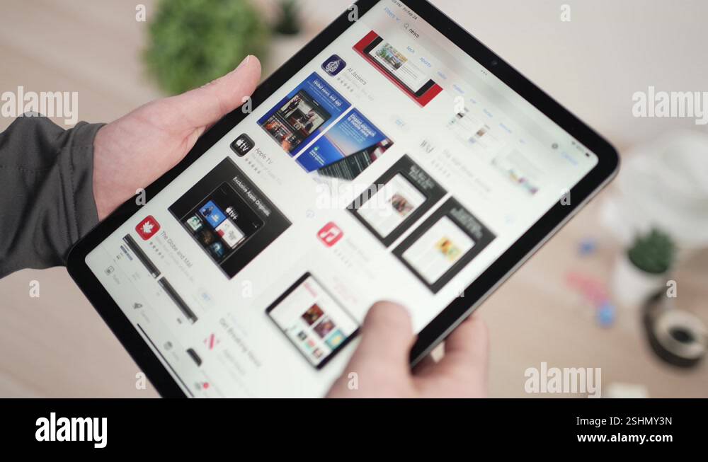 Browsing News Apps To Download on an iPad Tablet To Get Informed Stock ...