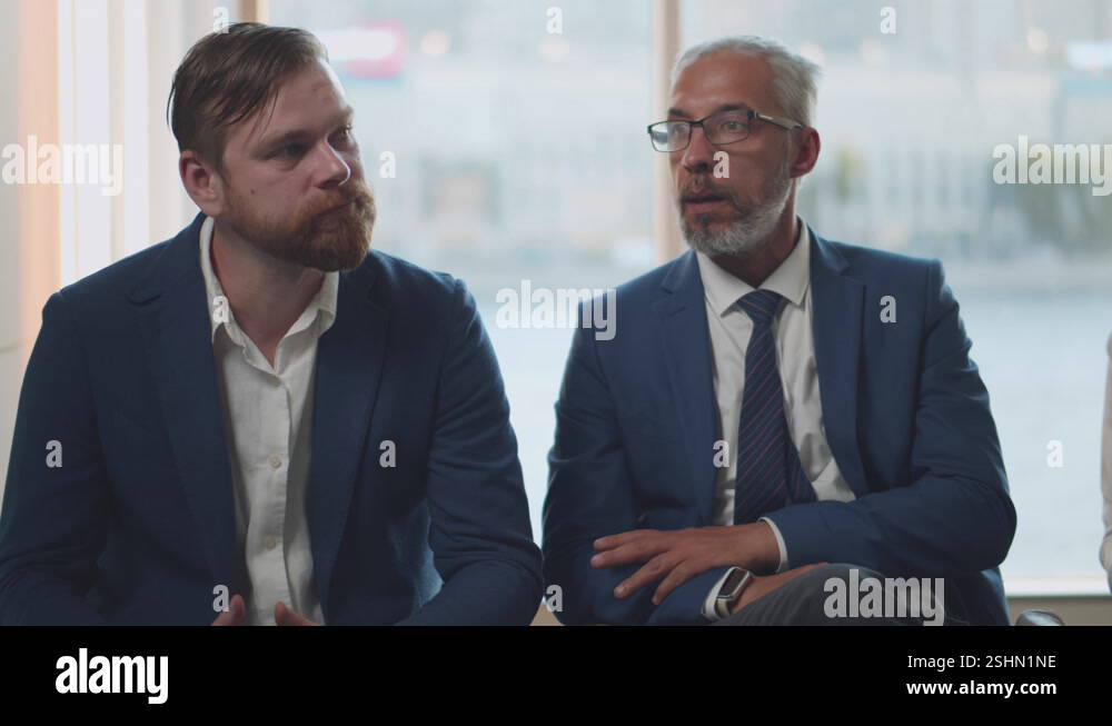 Applicants of different age waiting for their turn sitting in line ...