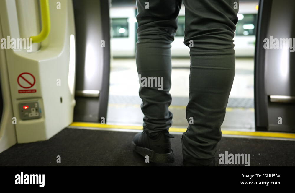 Person legs leaving subway train on platform. Close up legs on exiting ...