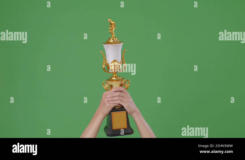 Raised Hands Of A Man Are Holding A Trophy. Green Screen Background ...