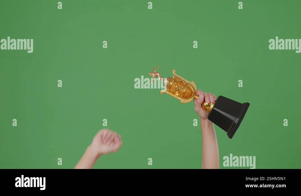 Raised Hands Of A Man Are Holding A Trophy. Green Screen Background ...