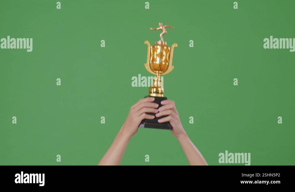 Raised Hands Of A Man Are Holding A Trophy. Green Screen Background ...
