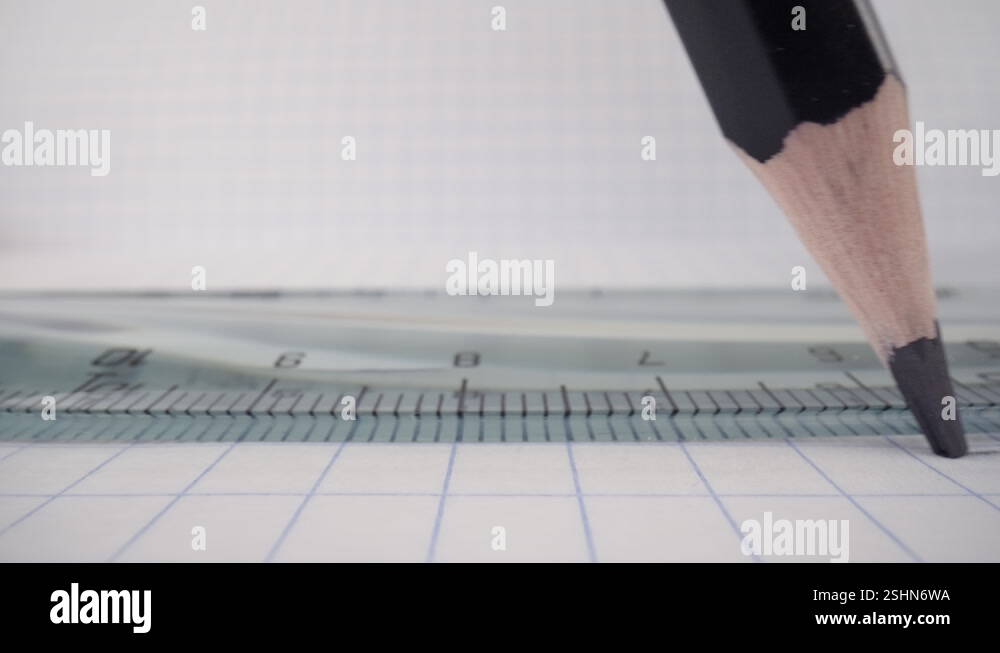 Dolly shot macro drawing straight line with pencil and ruler on white ...