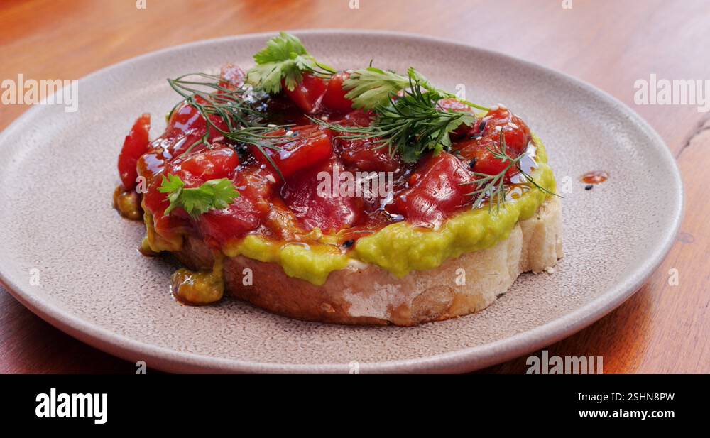 Appetizing tuna ceviche sandwich, close up shot, taking piece of fish ...
