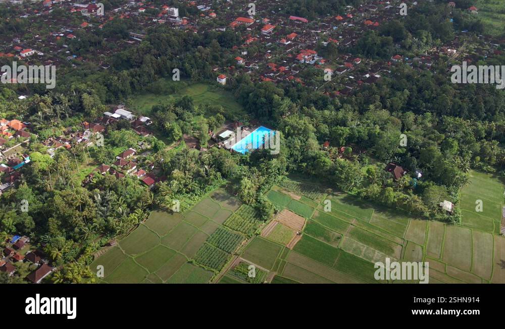 Aerial View Of Lush Farm Fields With An Outdoor Pool In Rural Village ...