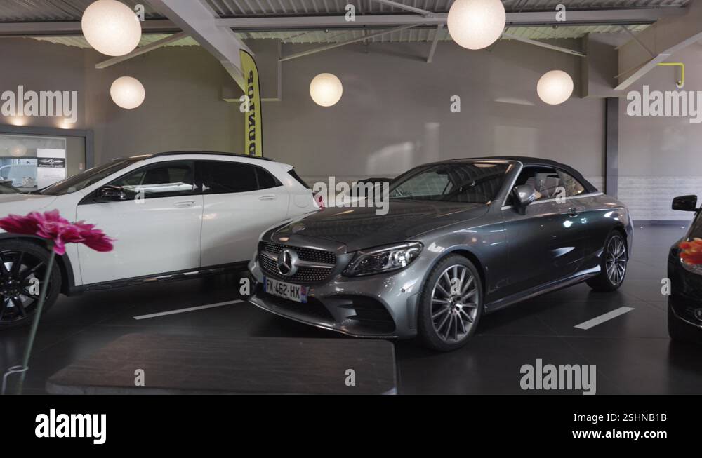 Dolly shot revealing the wide range of Mercedes-Benz cars on sale in a ...