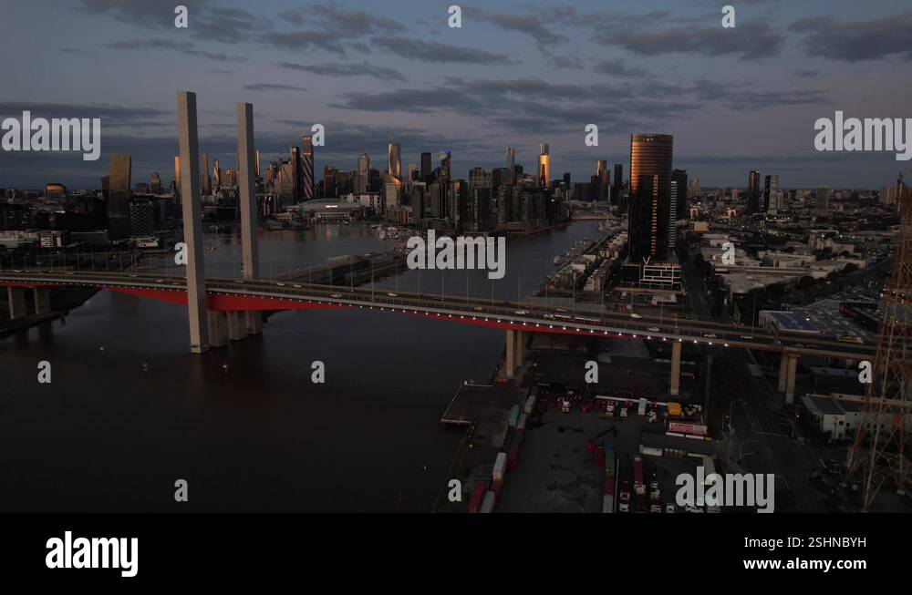 Large twin cantilever road bridge over Yarra river, Melbourne skyline ...