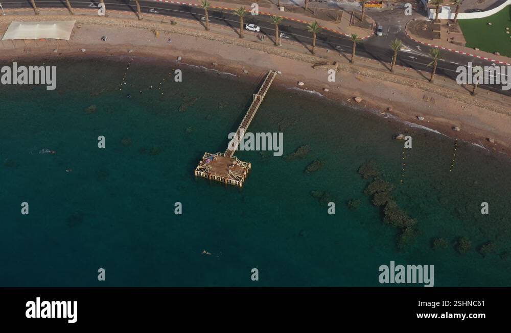 panning up drone view moving across a protected coral reef marine park ...