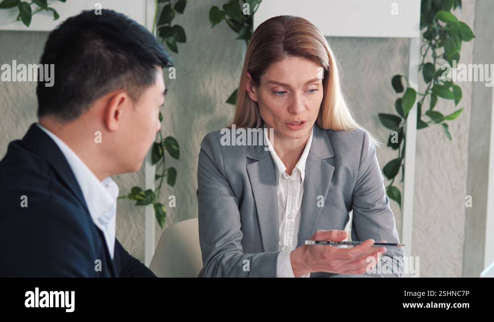Two diverse multinational business men partners talking, working ...