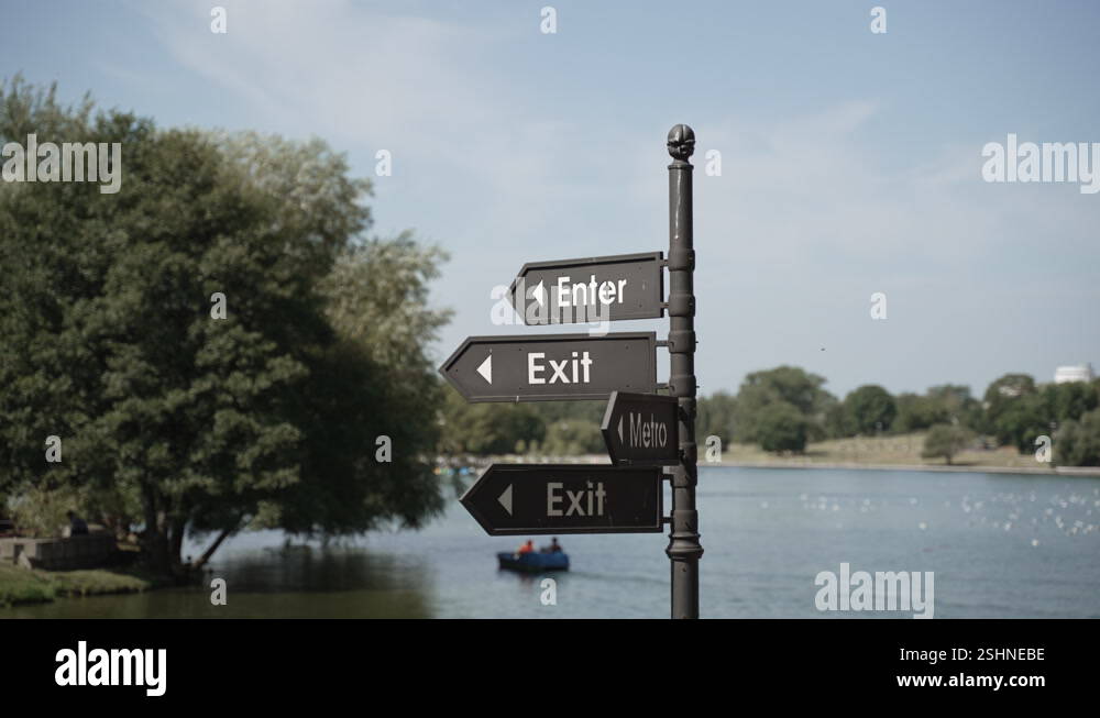 Signpost directions of entry and exit pillar on river embankment on ...