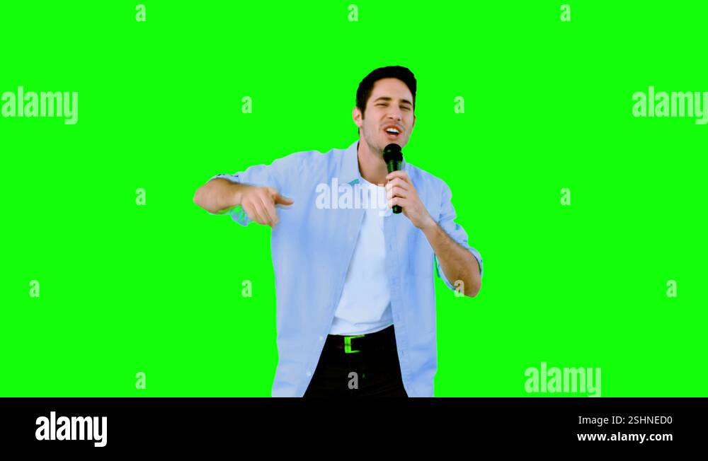 Man singing into microphone on green screen Stock Video Footage - Alamy