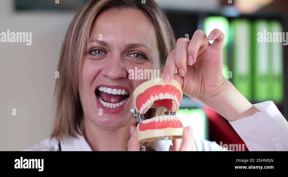 Doctor dentist opening mouth and artificial plastic jaw model 4k movie slow Stock Video Footage ...