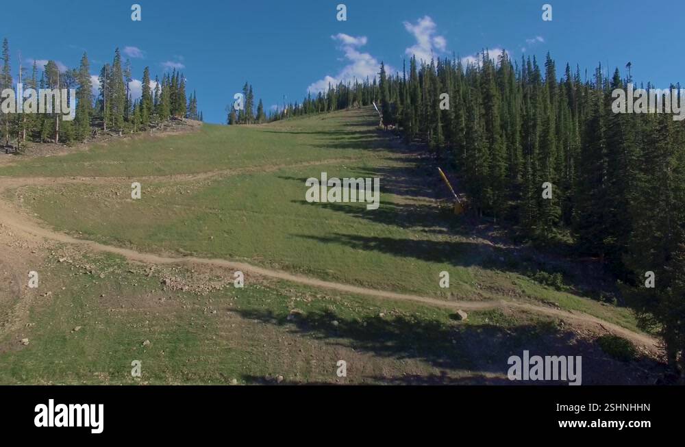 Mountain biker rides and jumps down switchback trail in Keystone ...