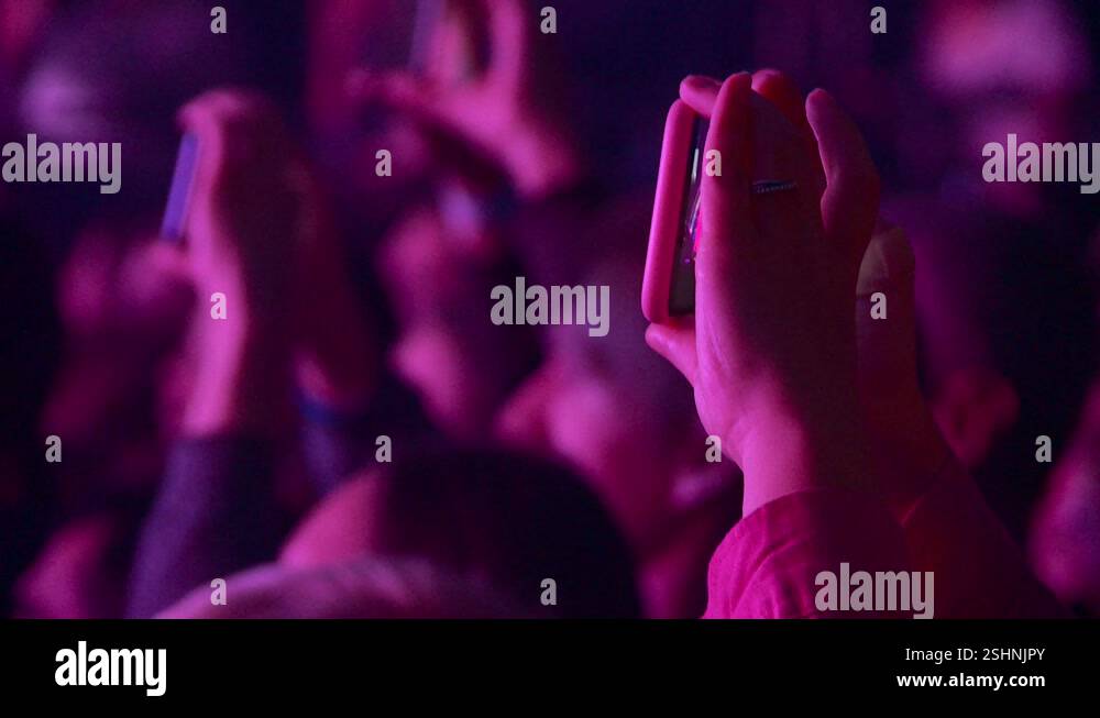 a large crowd of spectators at a rock concert in Moscow shoots a B-2 ...