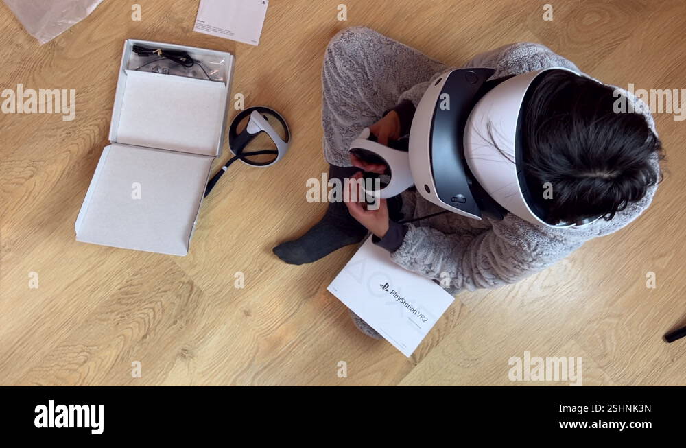 A boy unboxing and setting up the Sony PS5 VR2 virtual reality headset ...