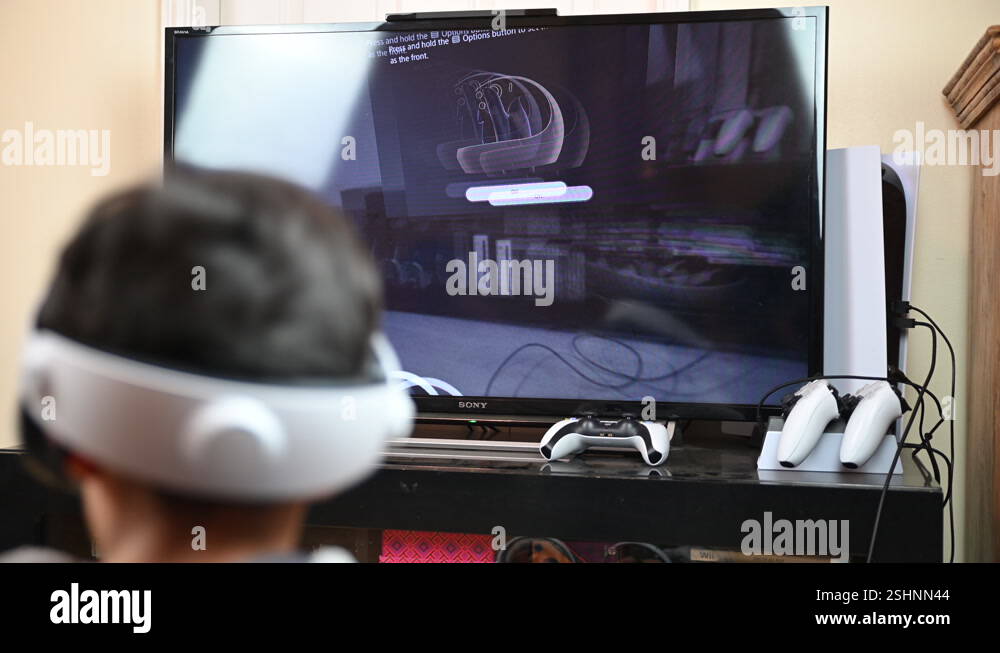 A boy unboxing and setting up the Sony PS5 VR2 virtual reality headset ...