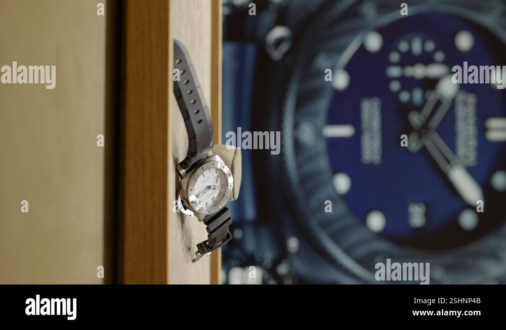 Vertical video of watch displayed on surface with giant watch poster ...