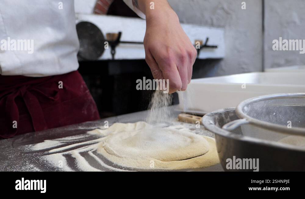 A close-up the chef pours special flour for pizza and dough Stock Video ...
