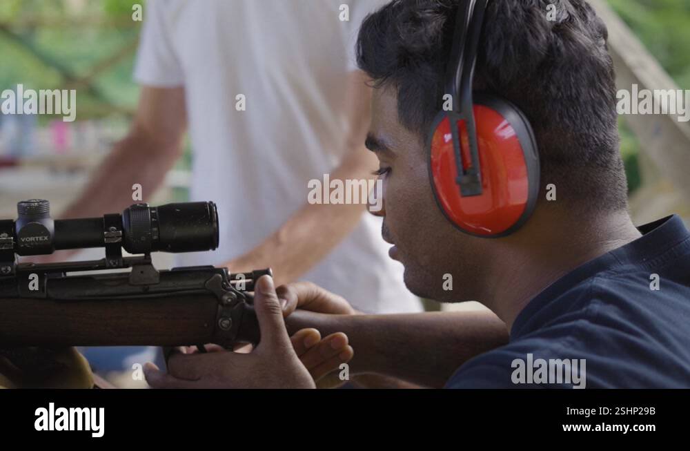 Instructor Assist Man Holding Rifle Aiming On Target At Firing Range ...