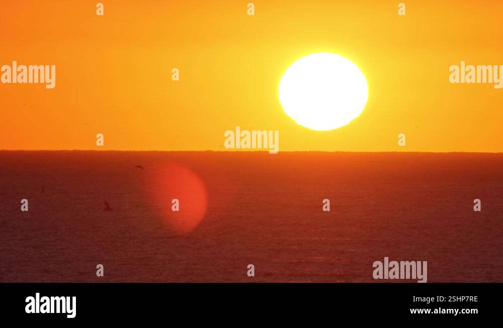 Red sunsets over sea video . The sun touches horizon. Red sky, yellow ...