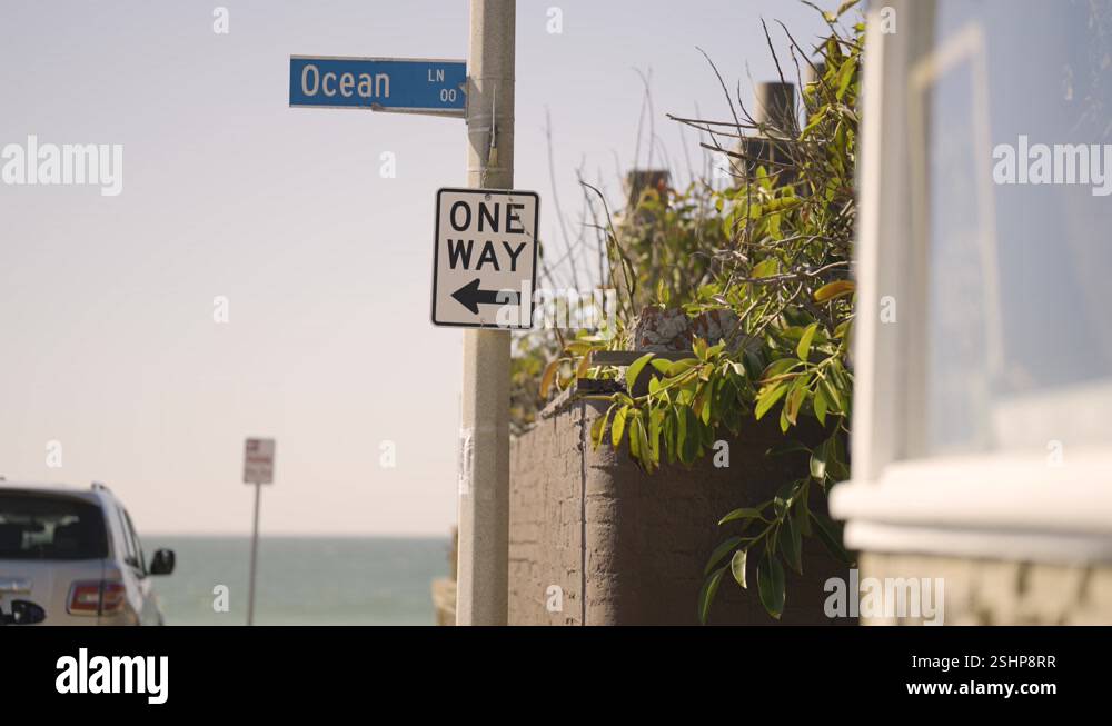 Blue Ocean Lane Street Sign with One Way Sign with Pacific Ocean in ...