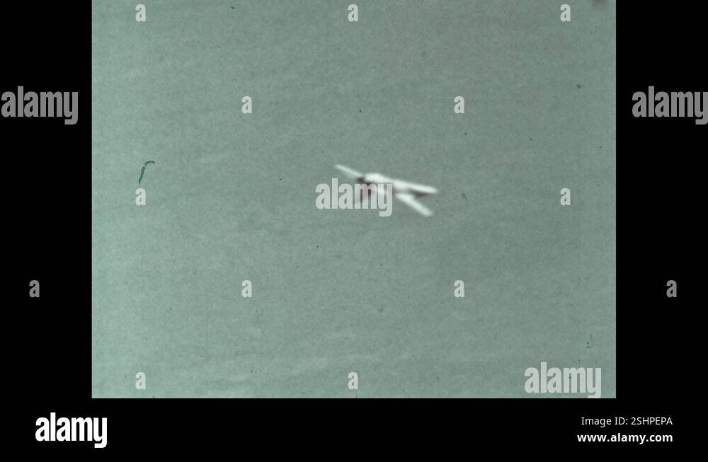 1960s: Plane does barrel rolls in sky. Landing gear comes out of plane ...