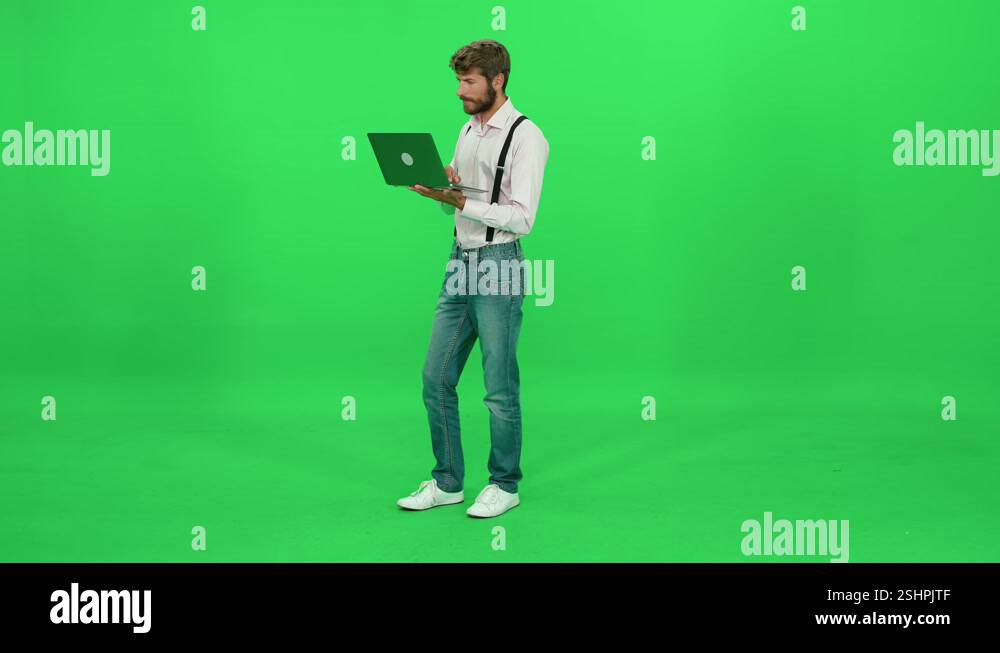 Journalist works on a laptop, typing and uses laptop on the go, green ...