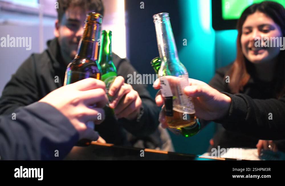 Toast toasts of friends drinking alcohol at night club . Fun time with ...