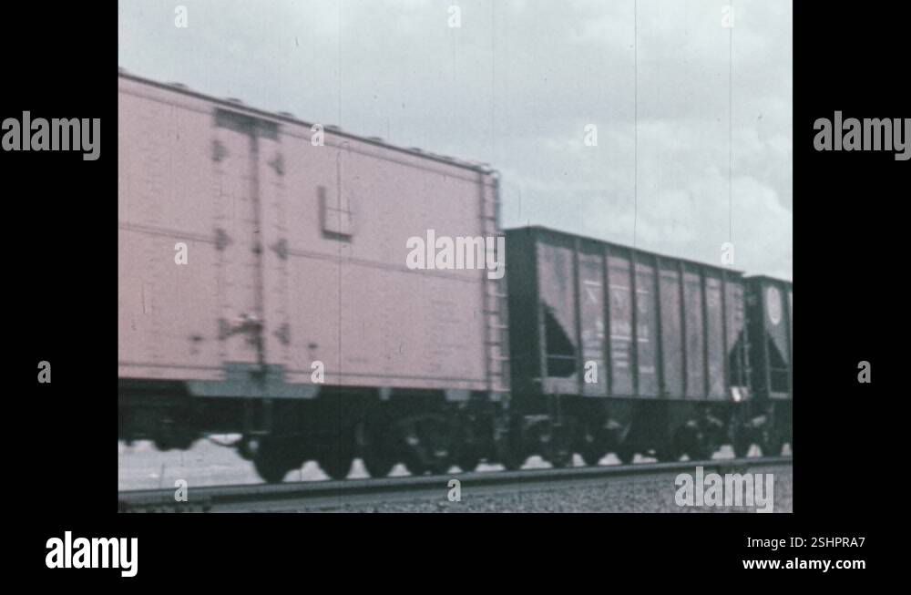 1950s: Shots of trains passing. Semi truck driving under bridge. Train ...