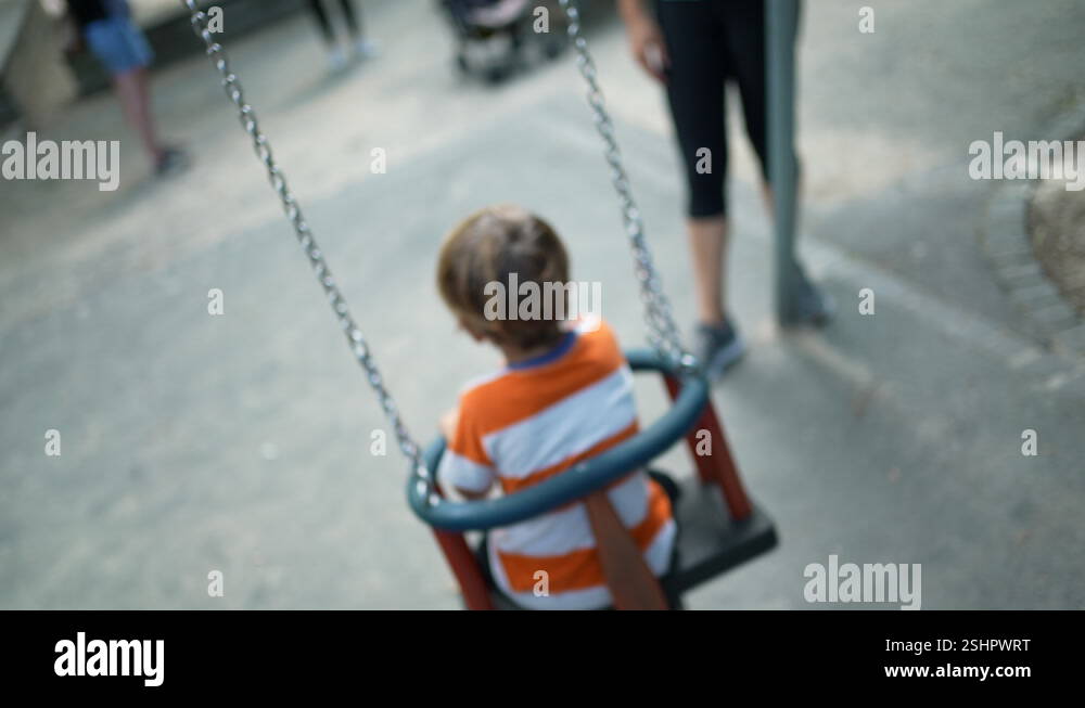 Child in playground swing. Parent pushing kid at park swing. Family weekend Stock Video Footage ...