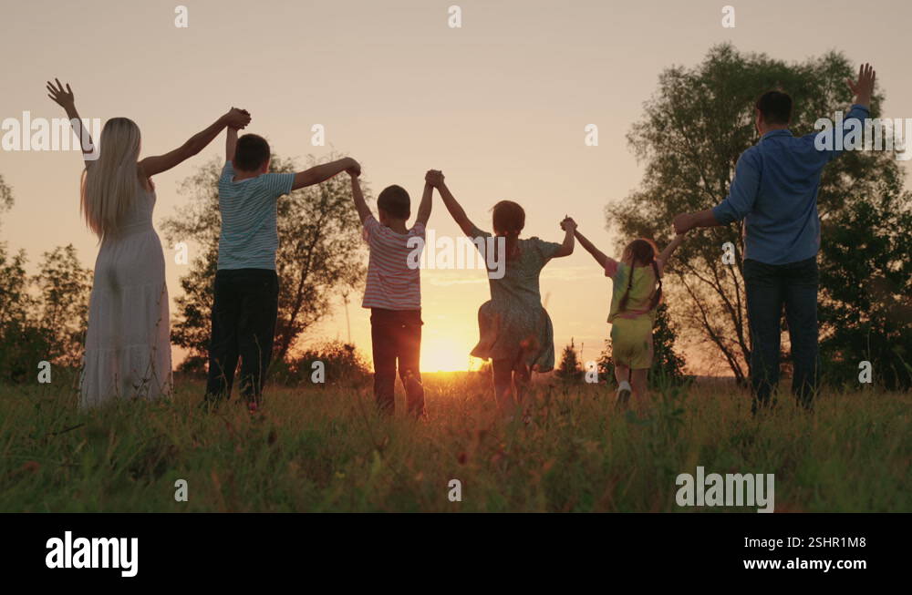 Parents, happy children, sun. Prayer of people. Big family, holding ...
