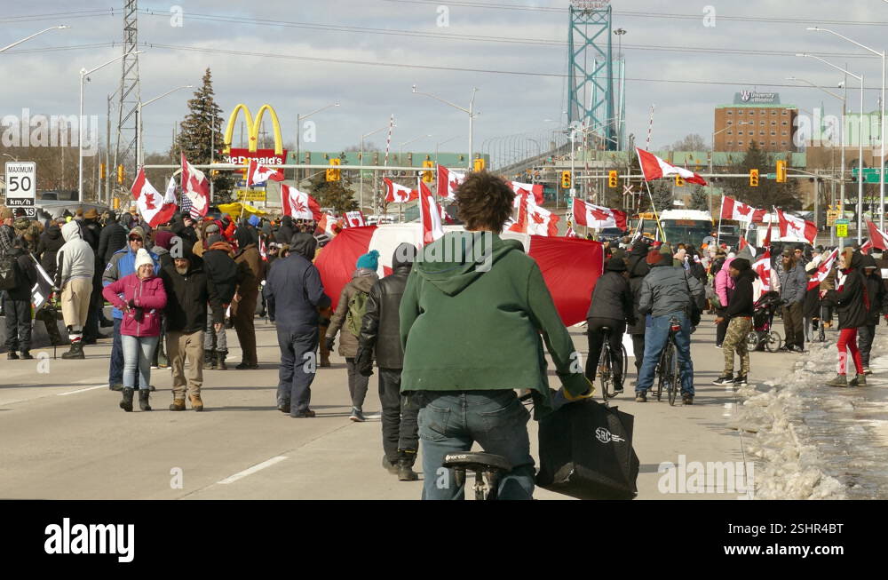 Massive crowd of people walking with a huge Canadian flag under a Stock ...