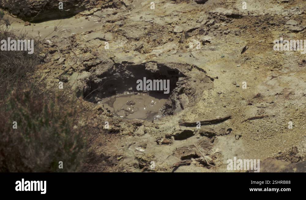 Brown Puddle of hot volcanic mud boiling hole and ground - Quality 4K ...