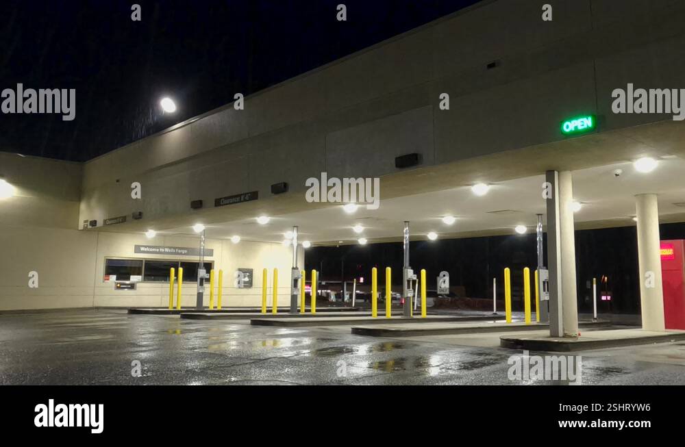 Wells Fargo banking drive thru at night in the rain traffic passing ...