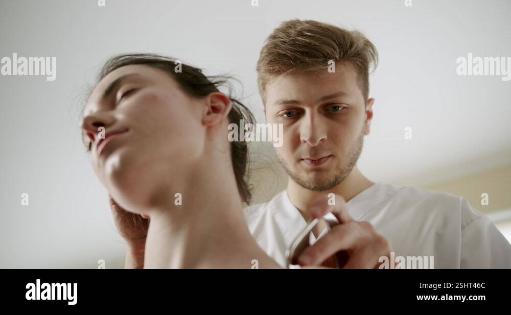 Fascia release soft tissue treatment on her neck with stainless steel ...