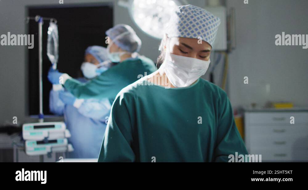Video of asian female surgeon checking instruments looks to camera in ...