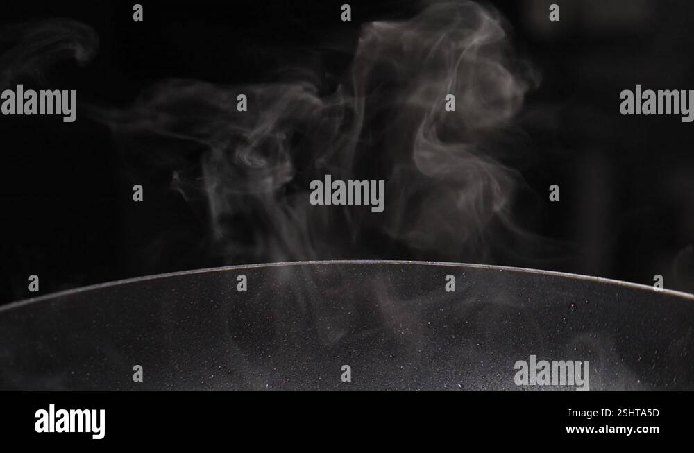 White smoke from pan while cooking on dark background, White smoke in ...