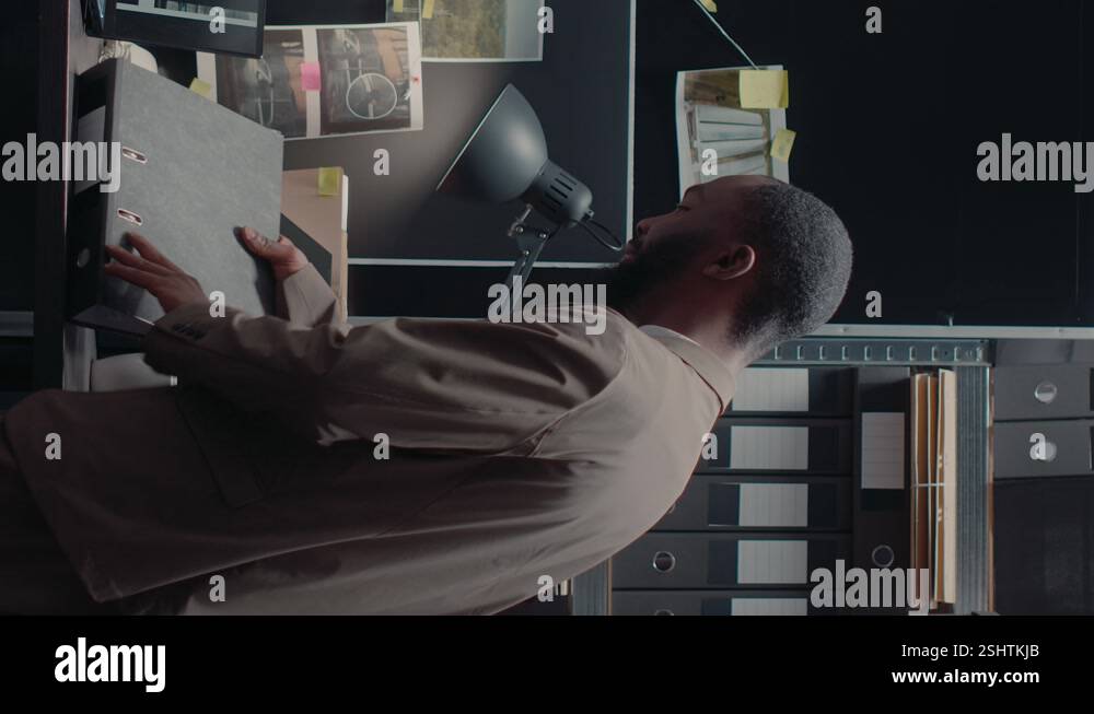 Vertical video: Private detectives checking crime scene photos on map ...