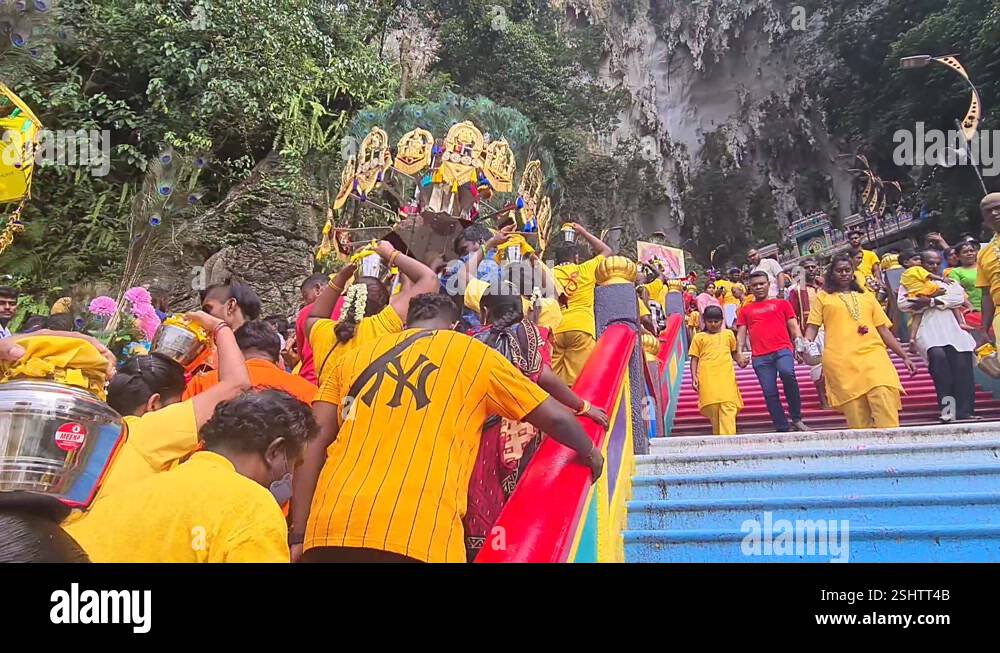 Hindu crowd walking towards Murugan temple with traditional big Kavadi ...