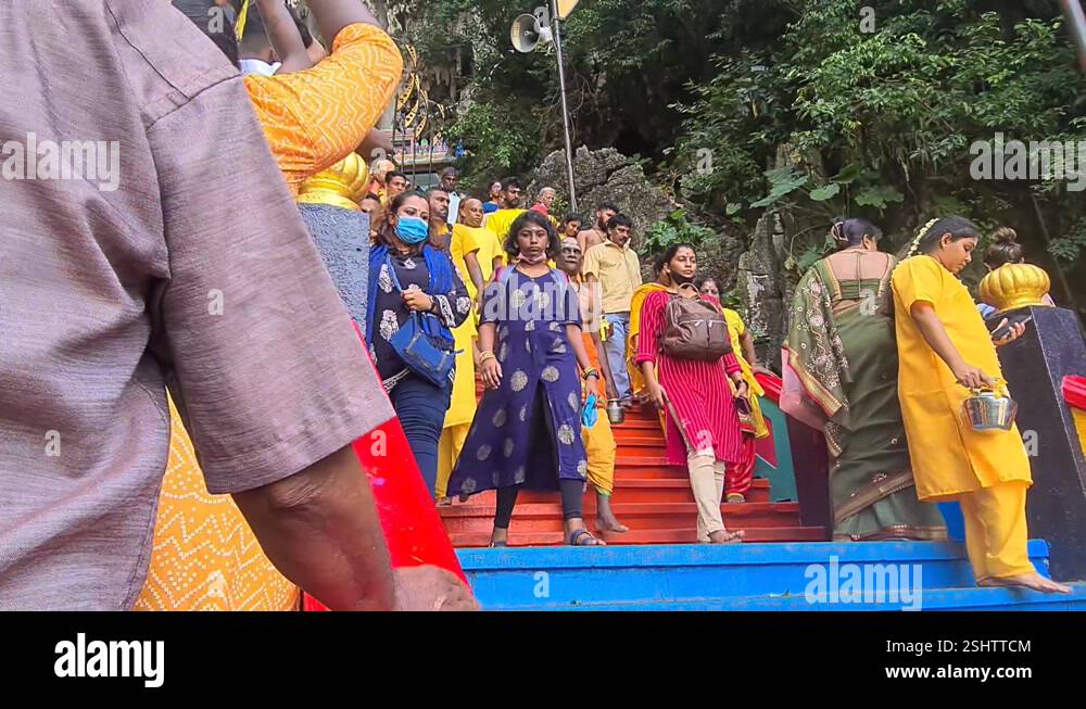 South Asian Hindus with Kavadi walking on stairs of Murugan temple on ...