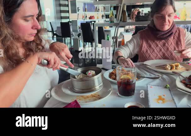 Female friends enjoying traditional Chinese dumplings together, sharing ...